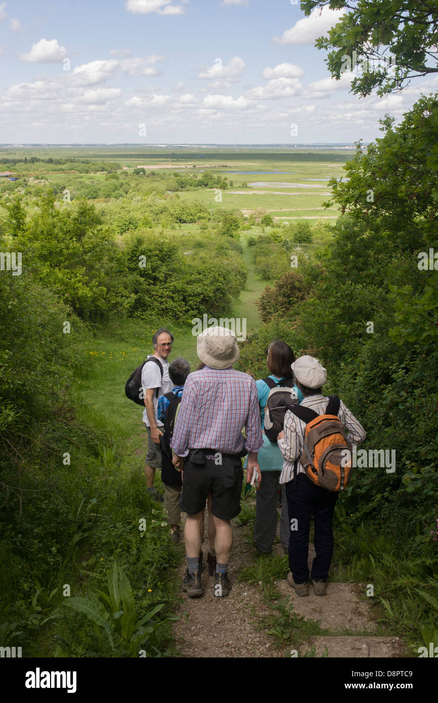A group of country ramblers look across Northwood Hill's landscape ...