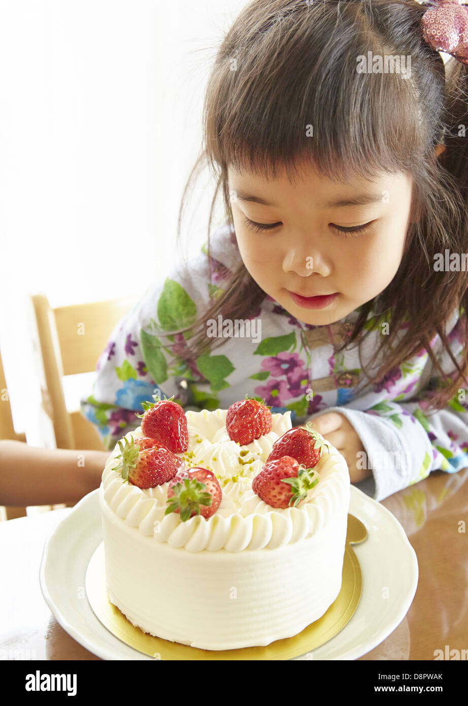 Girl looking at a cake Stock Photo - Alamy