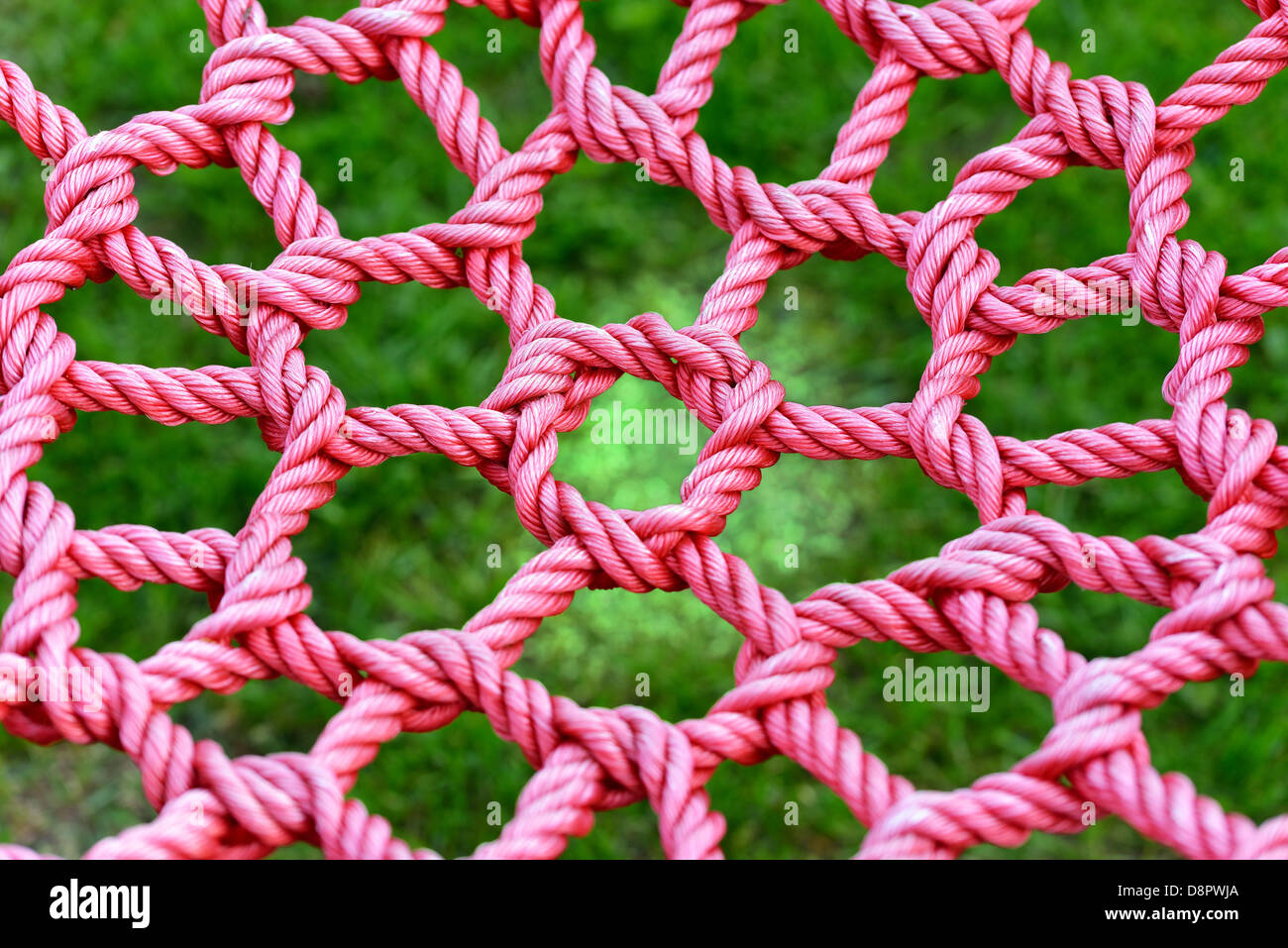 Red web in front of a green background Stock Photo - Alamy