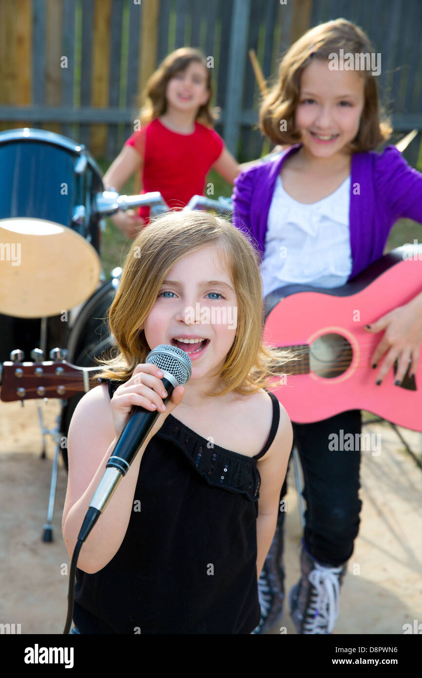 Blond kid singer girl singing playing live band in backyard concert ...