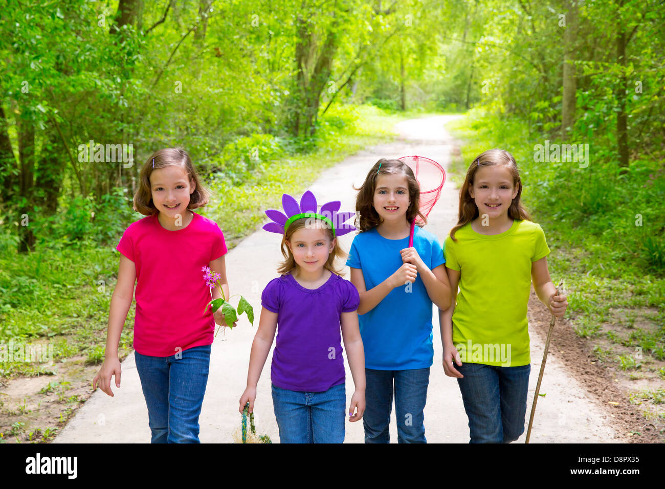 Friends and sister girls walking outdoor in forest track excursion ...