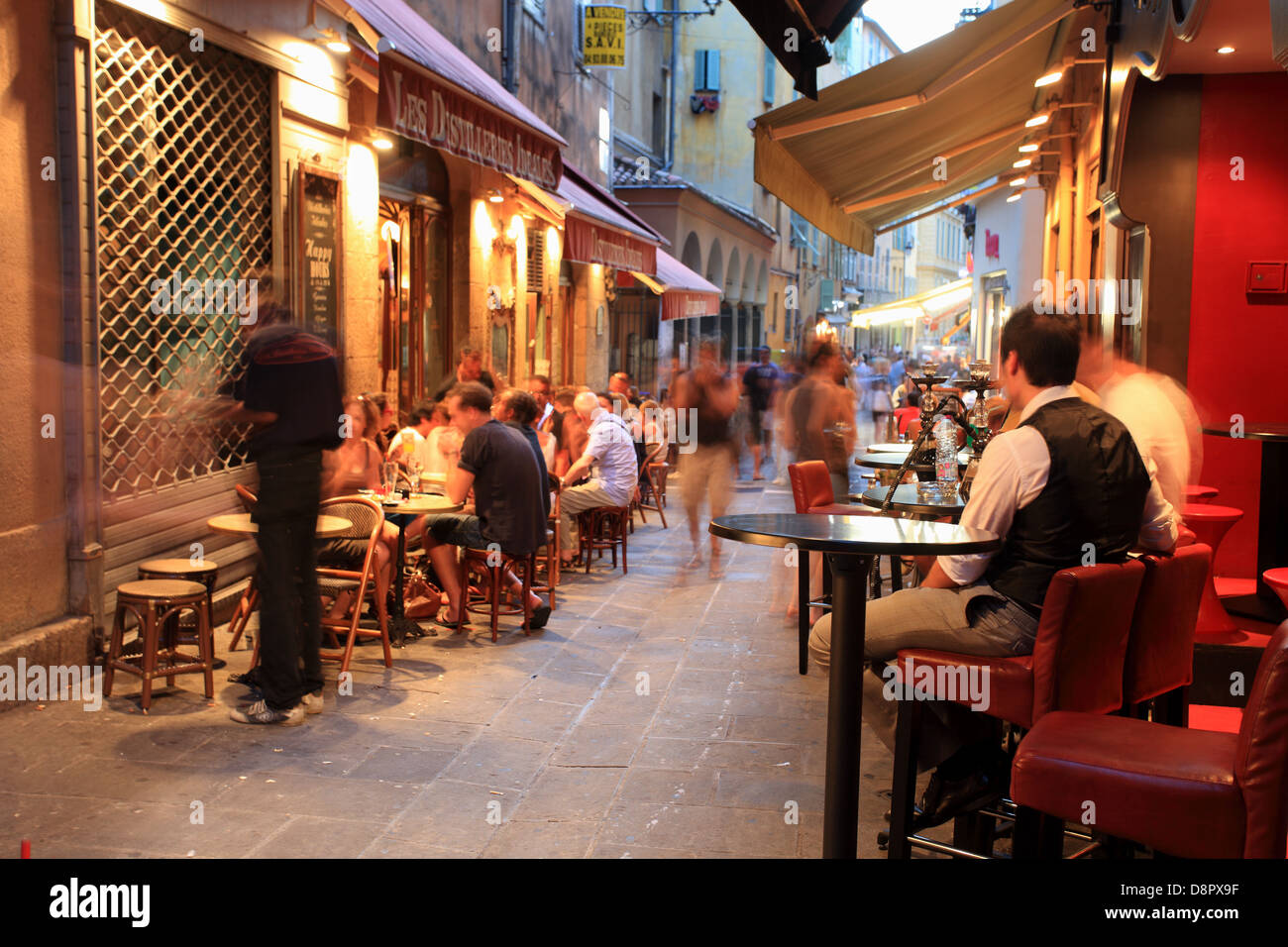 People having drinks outside in the old town of Nice city at night ...