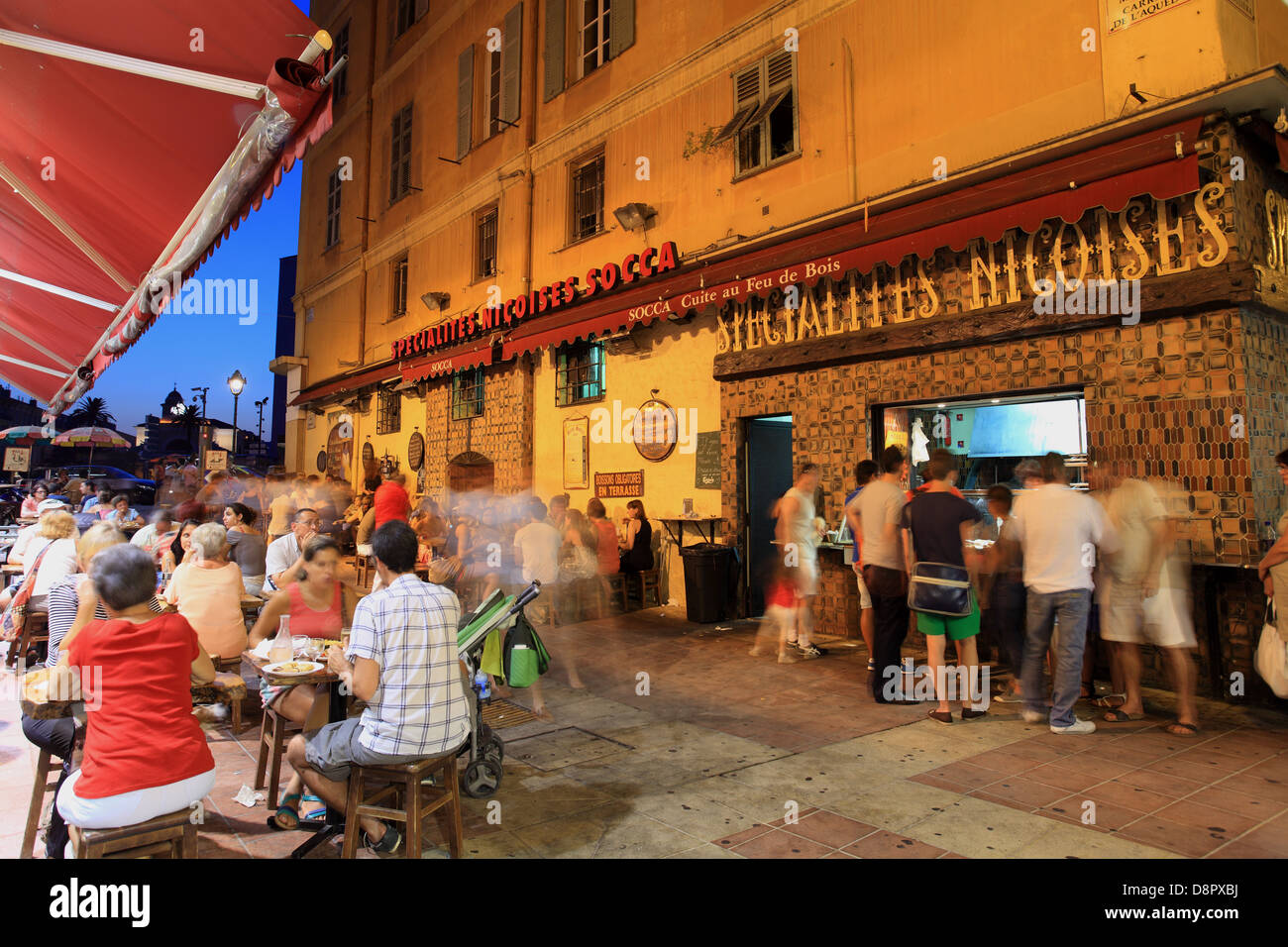 People having diner outside in a restaurant serving speciality like ...