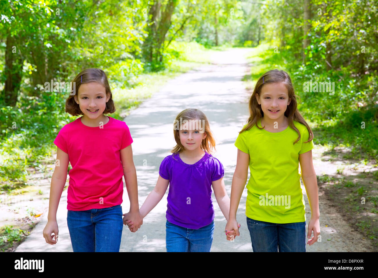Friends and sister girls walking outdoor in forest track excursion ...