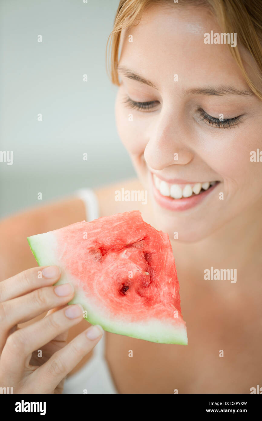 Young woman eating watermelon Stock Photo - Alamy