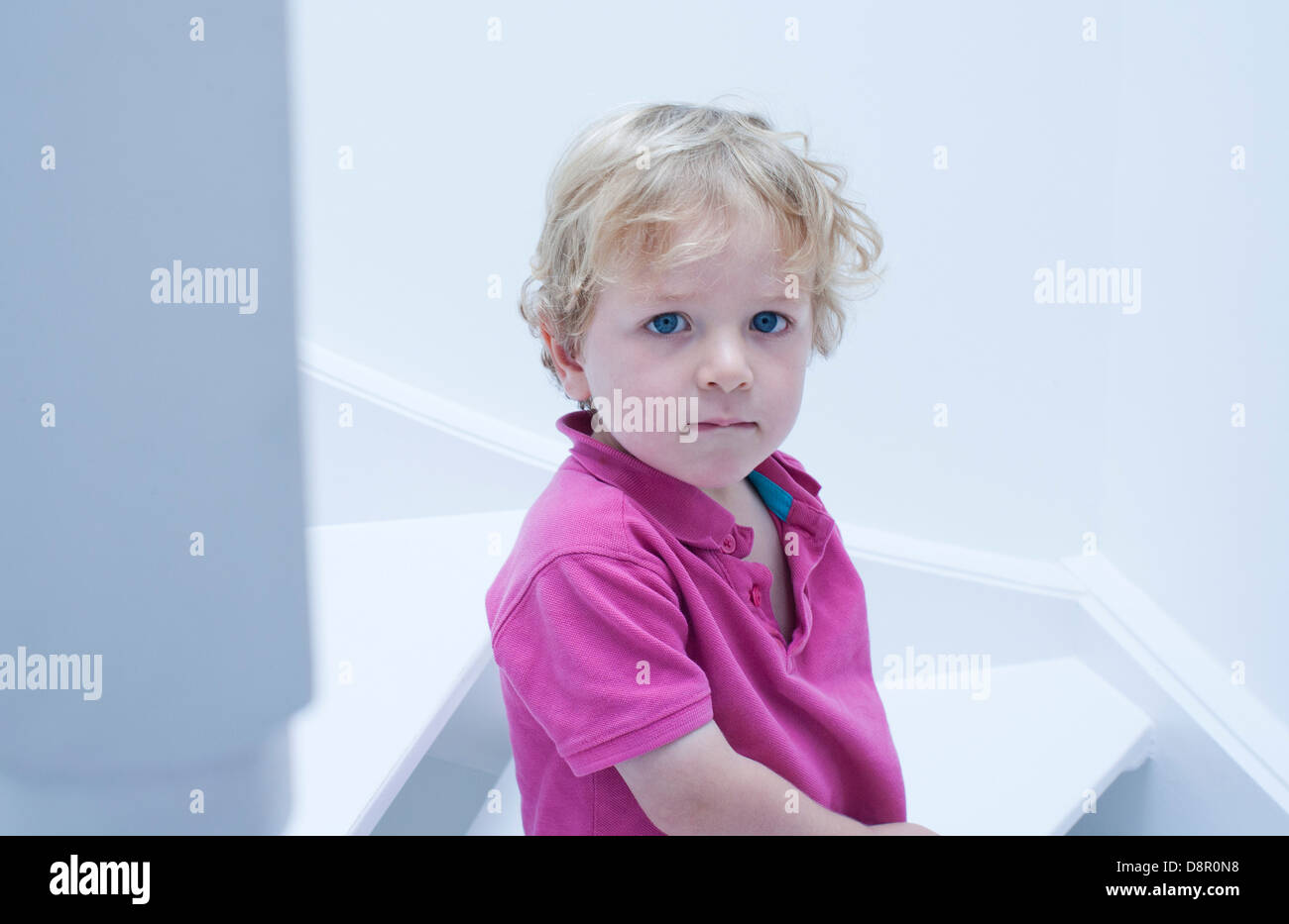 Little boy biting lips, portrait Stock Photo - Alamy