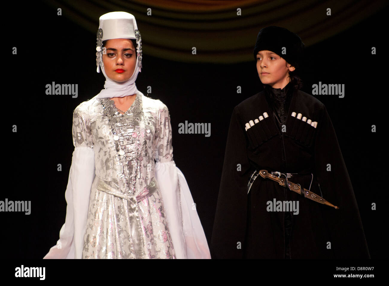 Georgian children dressed with traditional costumes dancing a folklore ...