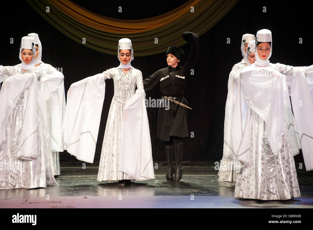 Georgian children dressed with traditional costumes dancing a folklore ...