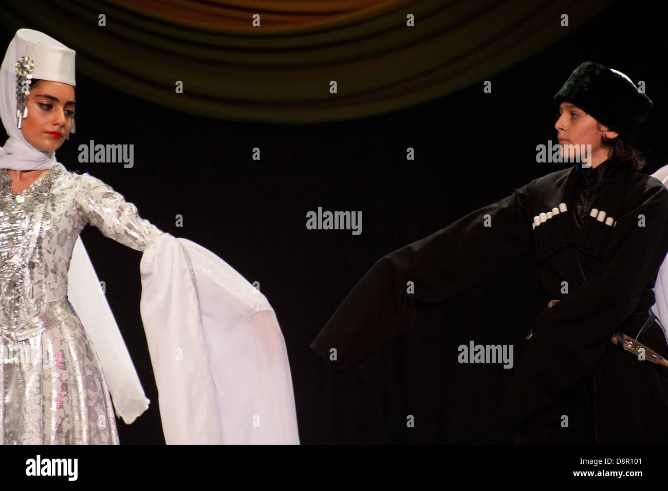 Georgian children dressed with traditional costumes dancing a folklore ...