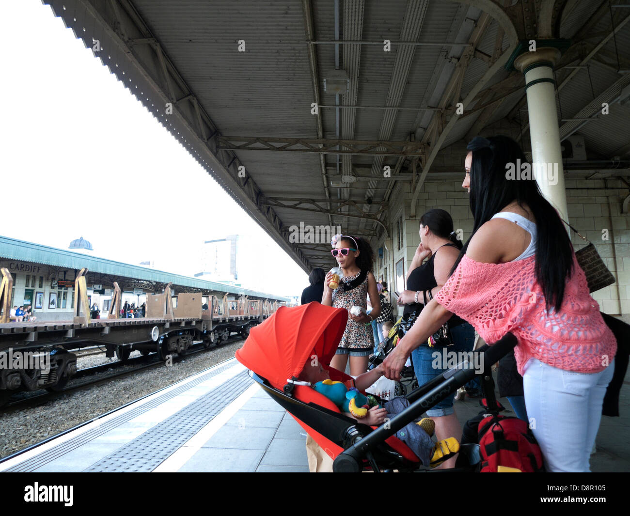 Family waiting for train on railway station platform Cardiff Central ...