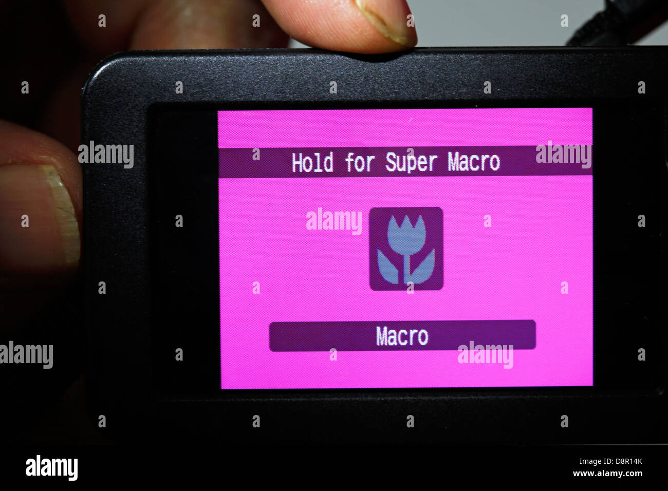 A camera's LCD display gives instructions on how to photograph in macro ...