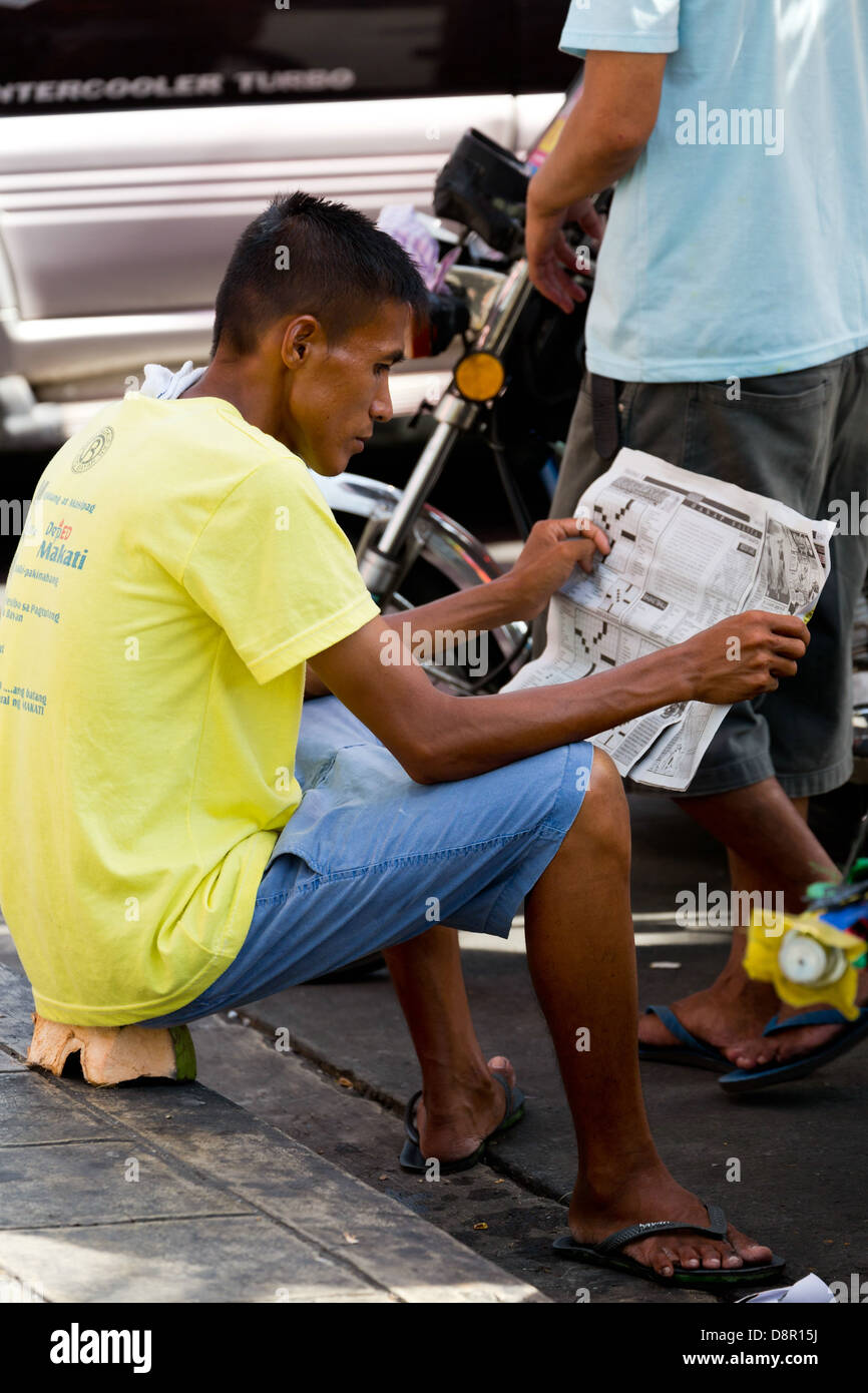 Man reading the News in the Streets of Manila, Philippines Stock Photo ...