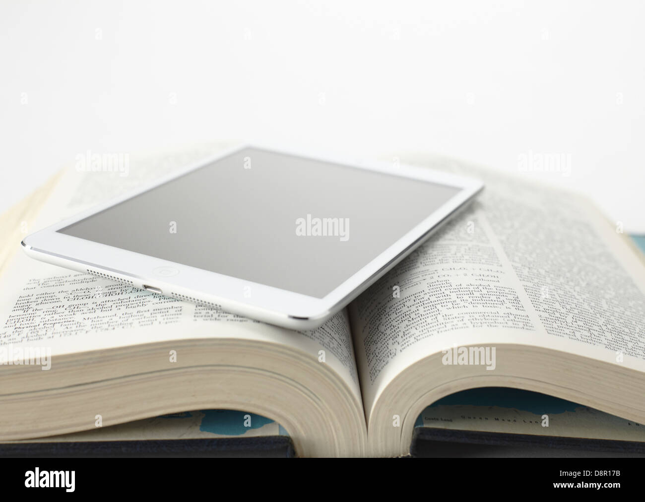 Encyclopedia and a tablet PC Stock Photo - Alamy
