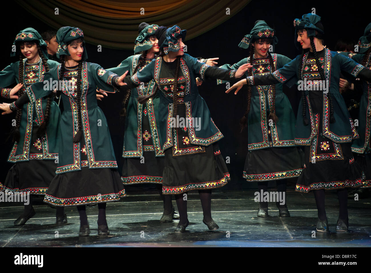 Georgian children dressed with traditional costumes dancing a folklore ...
