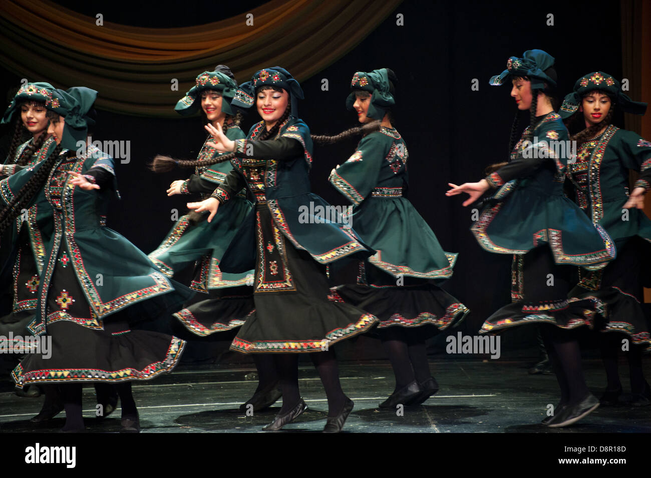 Georgian children dressed with traditional costumes dancing a folklore ...