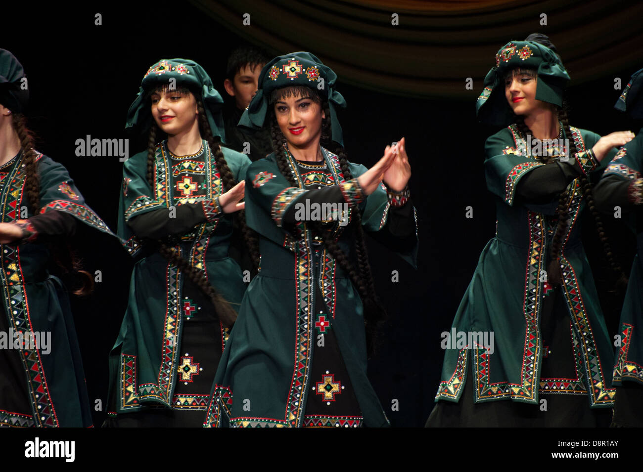 Georgian children dressed with traditional costumes dancing a folklore ...