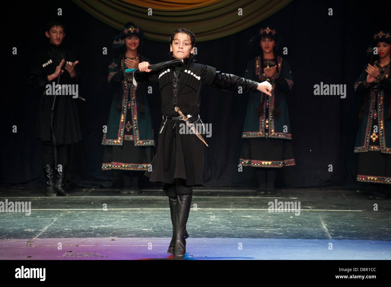 Georgian children dressed with traditional costumes dancing a folklore ...