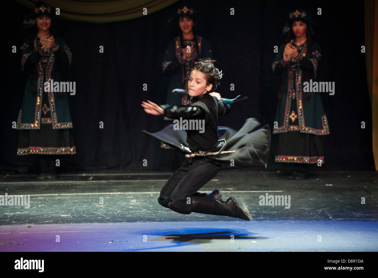 Georgian children dressed with traditional costumes dancing a folklore ...