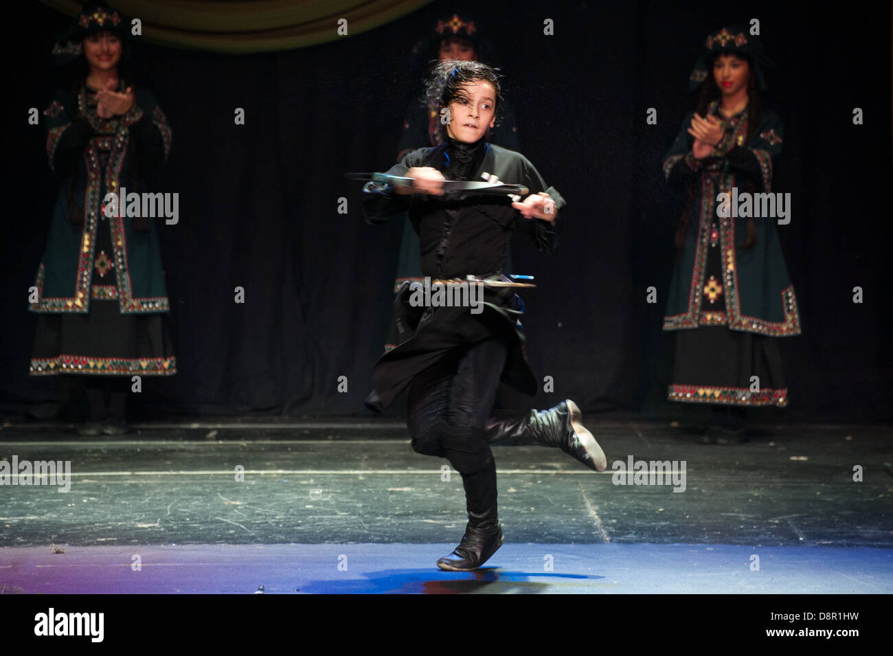 Georgian children dressed with traditional costumes dancing a folklore ...
