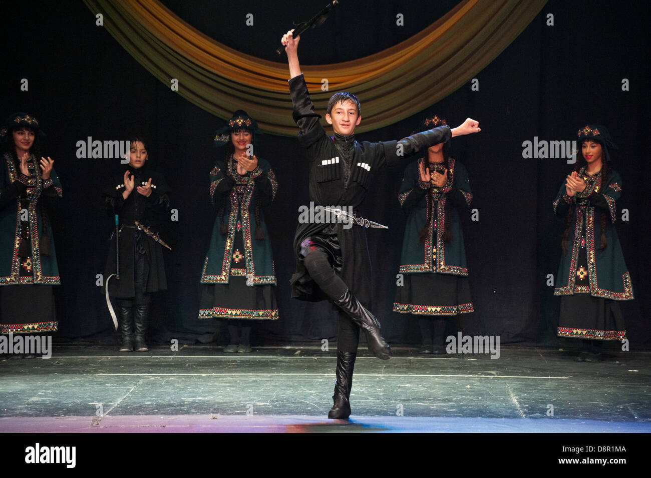 Georgian children dressed with traditional costumes dancing a folklore ...