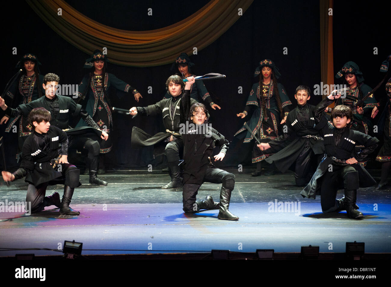 Georgian children dressed with traditional costumes dancing a folklore ...