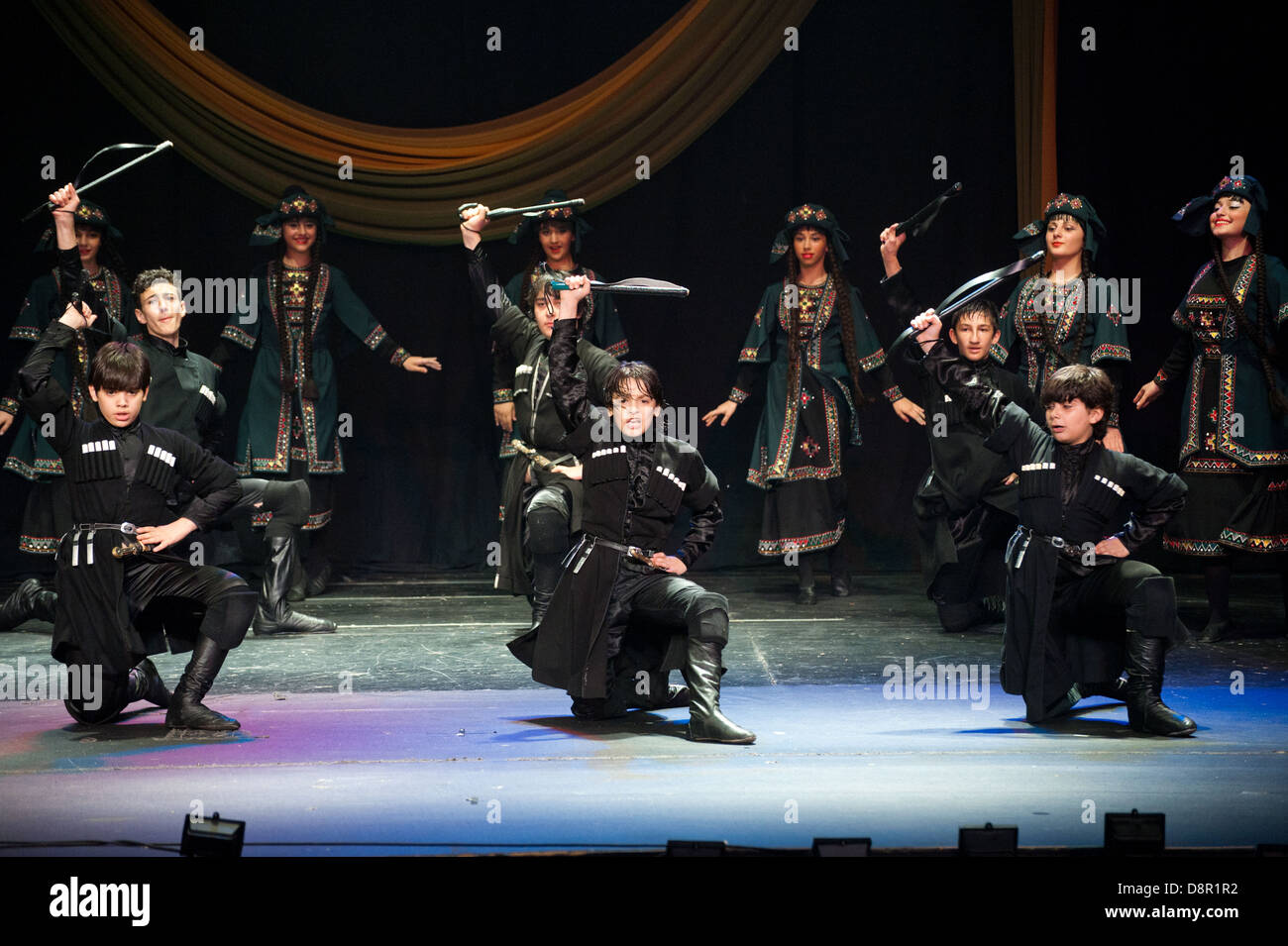 Georgian children dressed with traditional costumes dancing a folklore ...