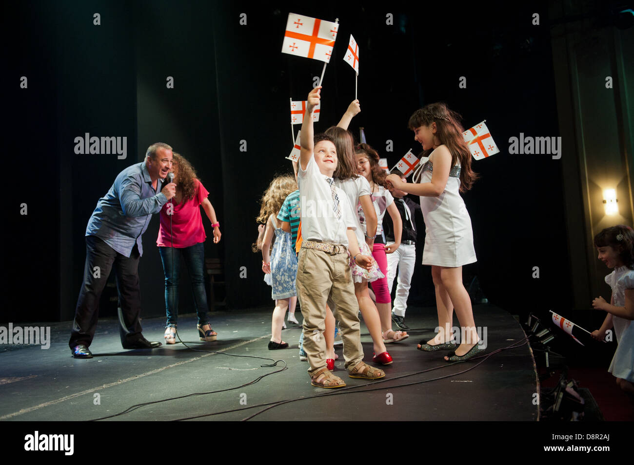Georgian children waving the Georgian national flag during a concert ...