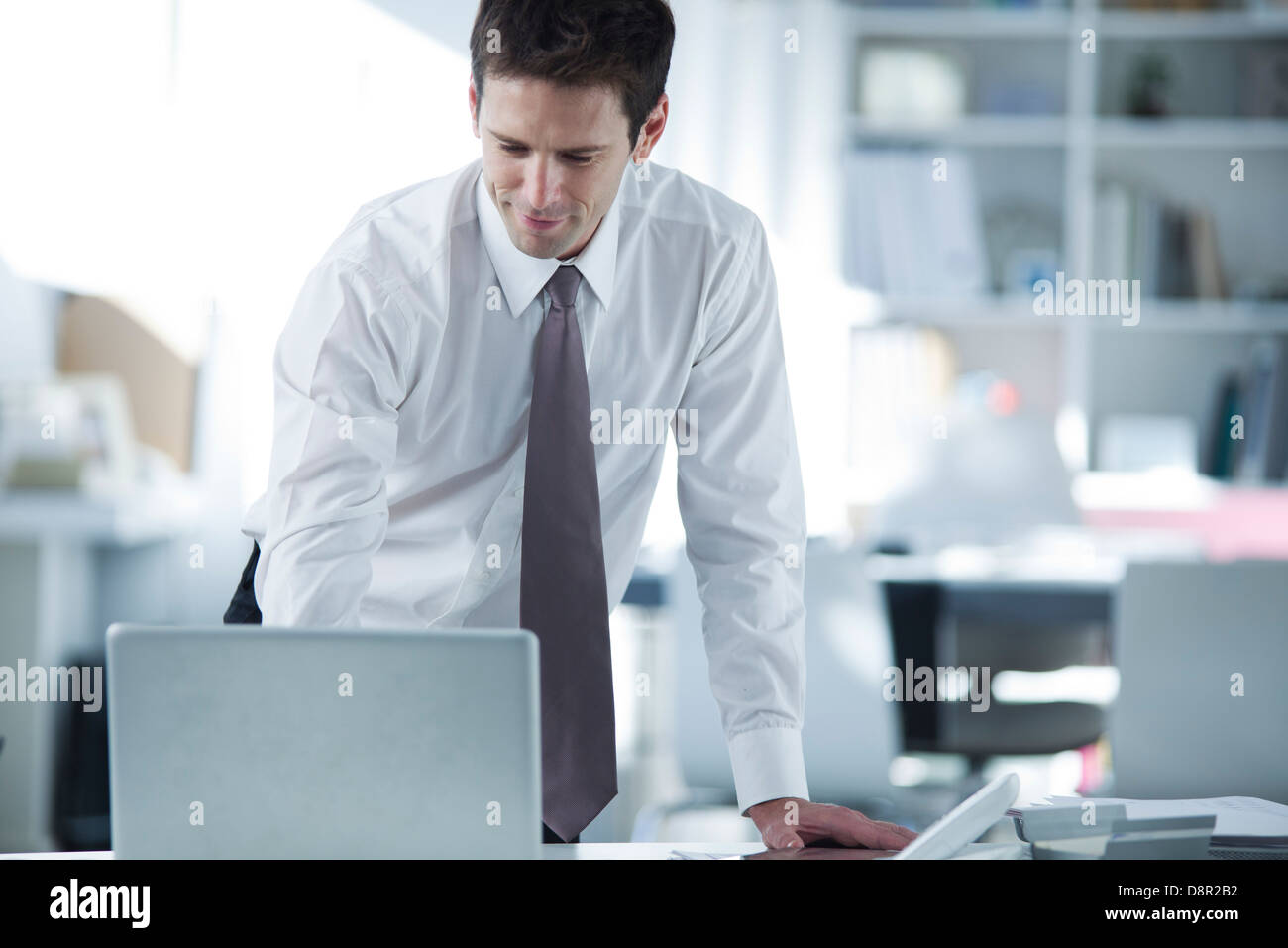 Businessman using laptop computer in office Stock Photo - Alamy Businessman using laptop computer in office Stock Photo - Alamy