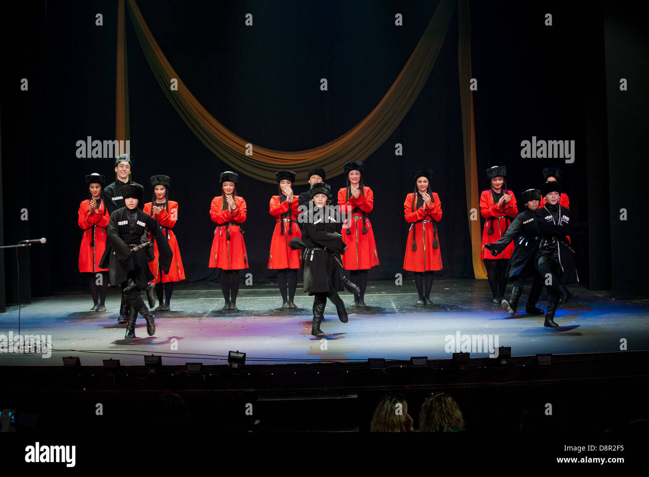 Georgian children dressed with traditional costumes dancing a folklore ...