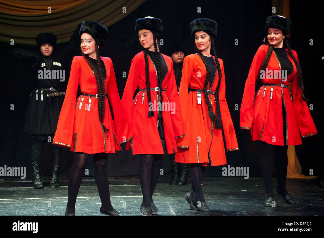 Georgian children dressed with traditional costumes dancing a folklore ...