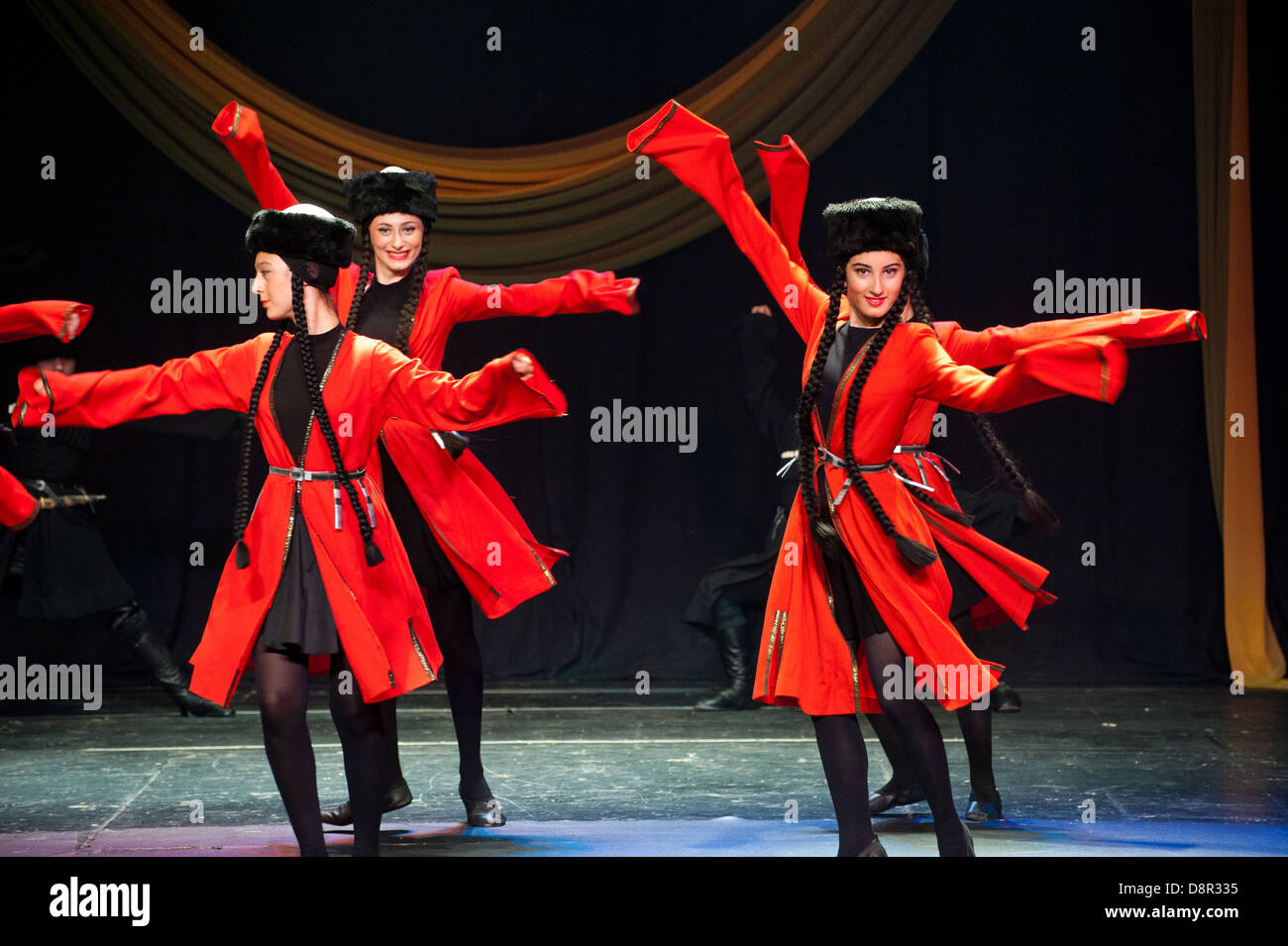 Georgian children dressed with traditional costumes dancing a folklore ...