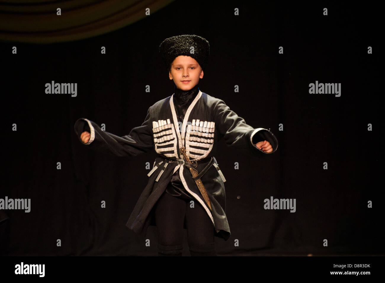 Georgian children dressed with traditional costumes dancing a folklore ...