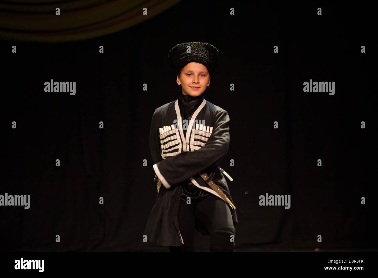 Georgian children dressed with traditional costumes dancing a folklore ...