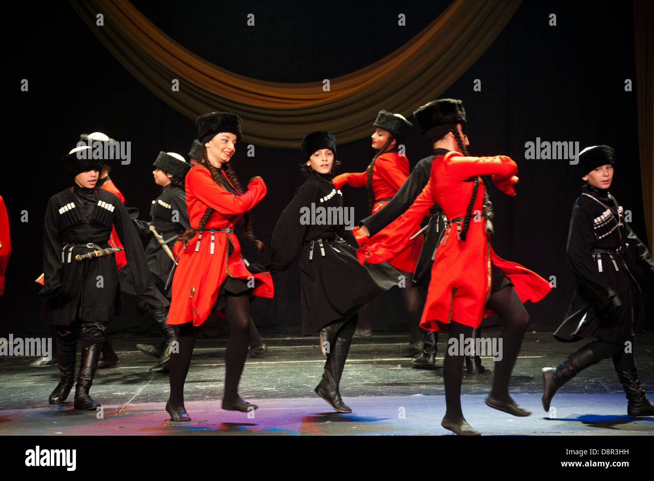 Georgian children dressed with traditional costumes dancing a folklore ...