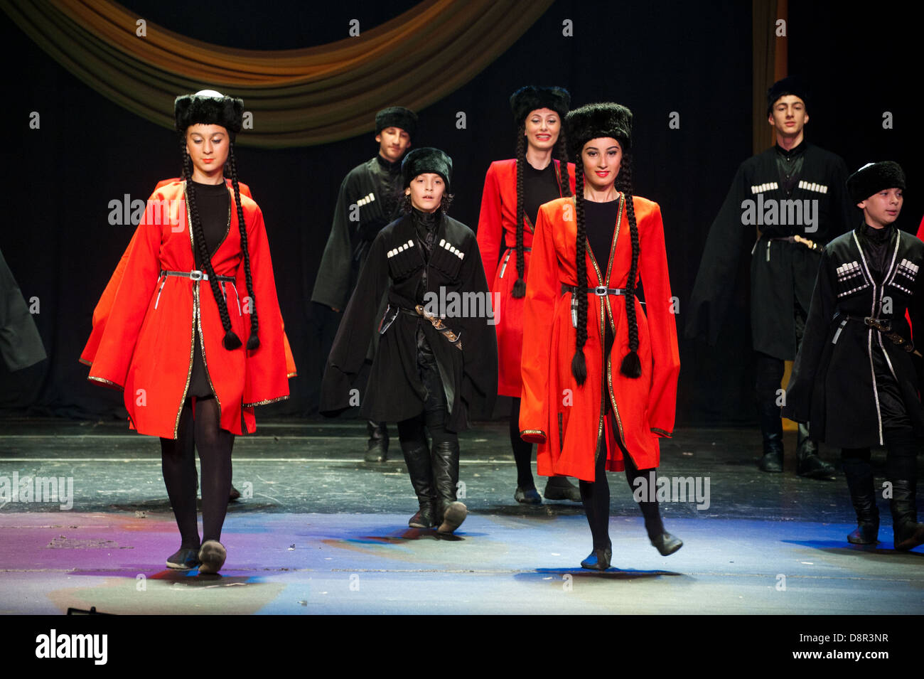 Georgian children dressed with traditional costumes dancing a folklore ...