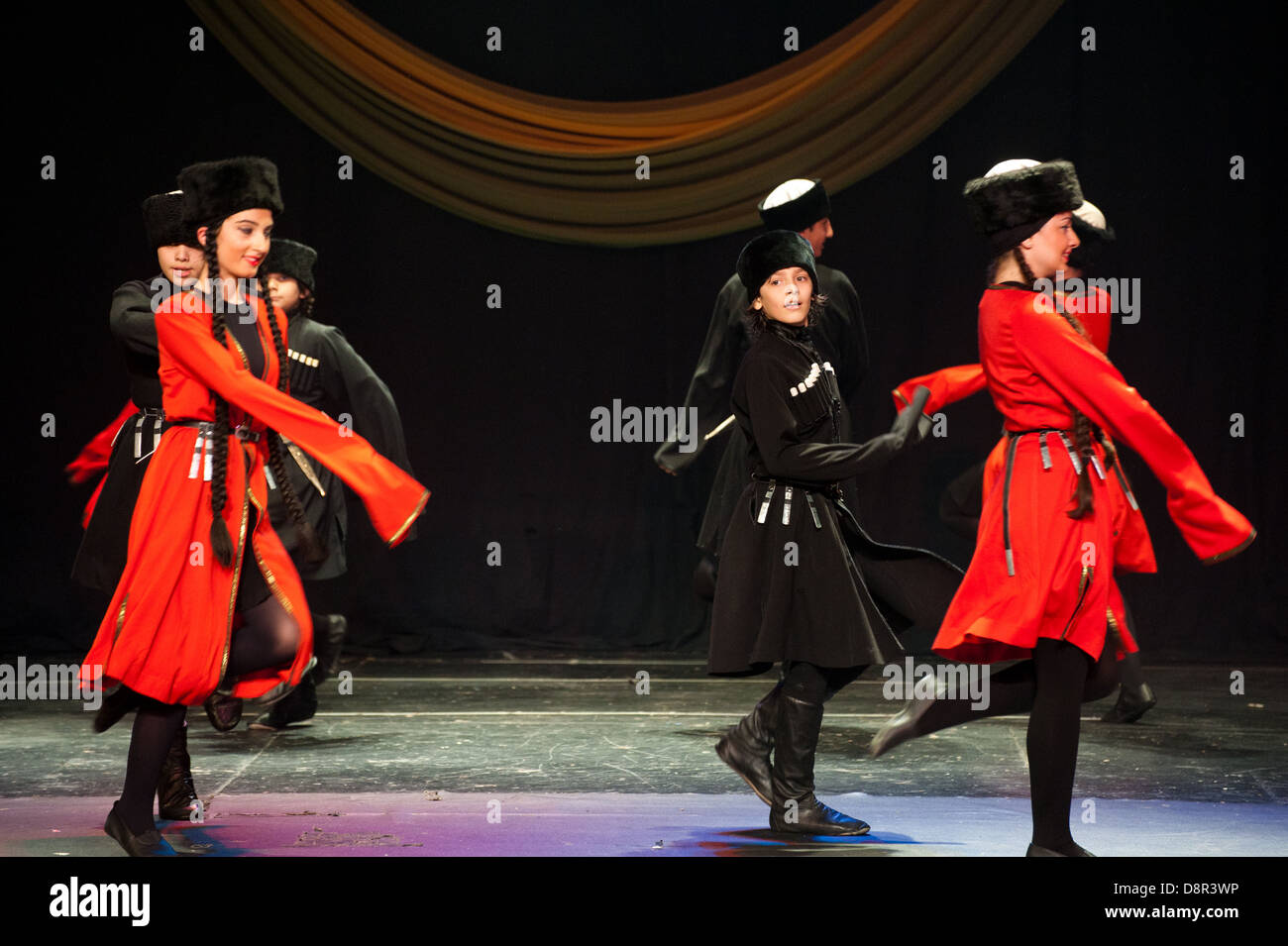 Georgian children dressed with traditional costumes dancing a folklore ...