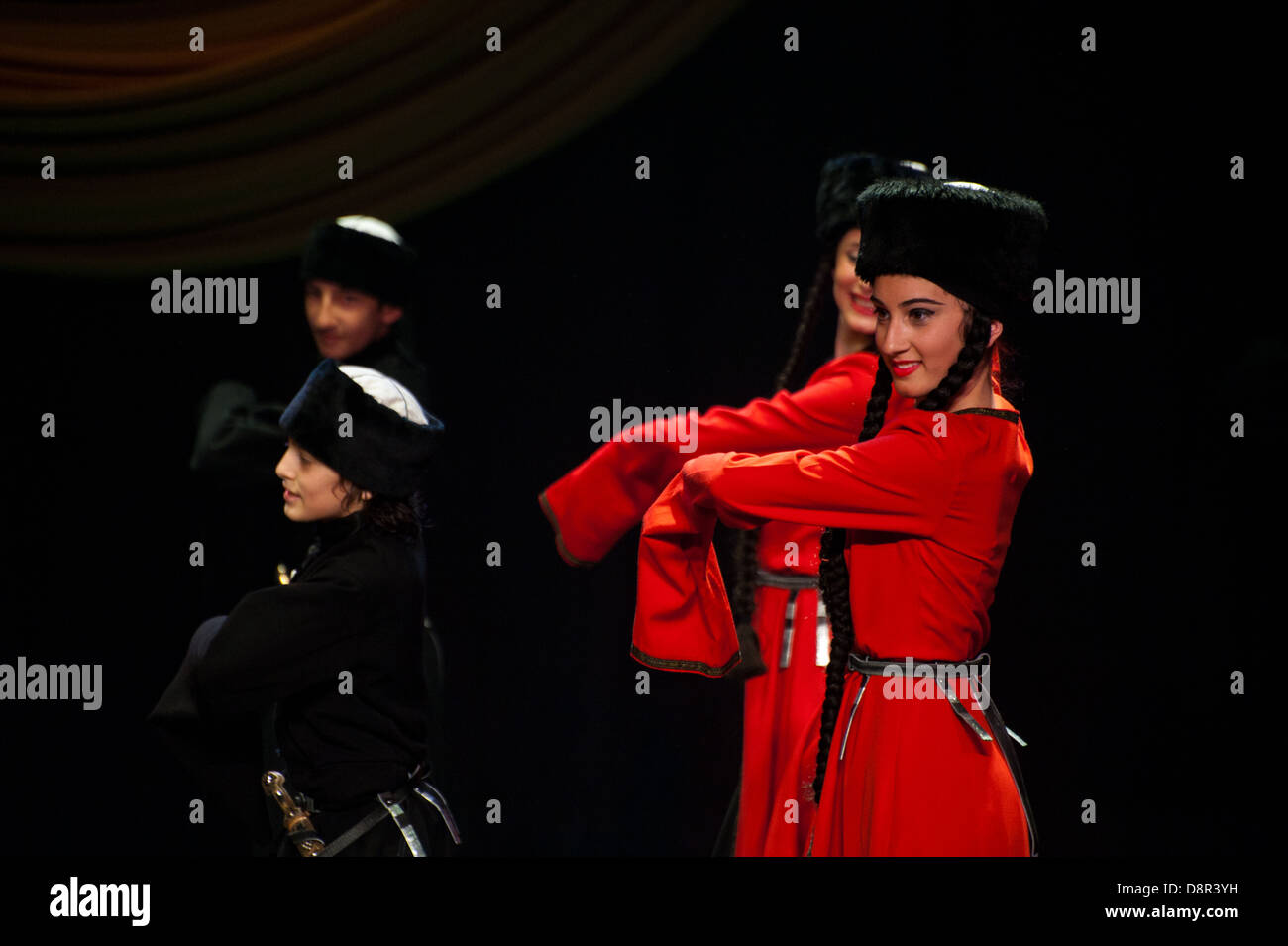 Georgian children dressed with traditional costumes dancing a folklore ...