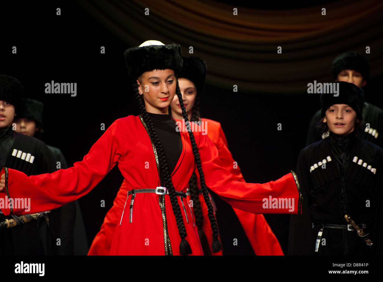 Georgian children dressed with traditional costumes dancing a folklore ...