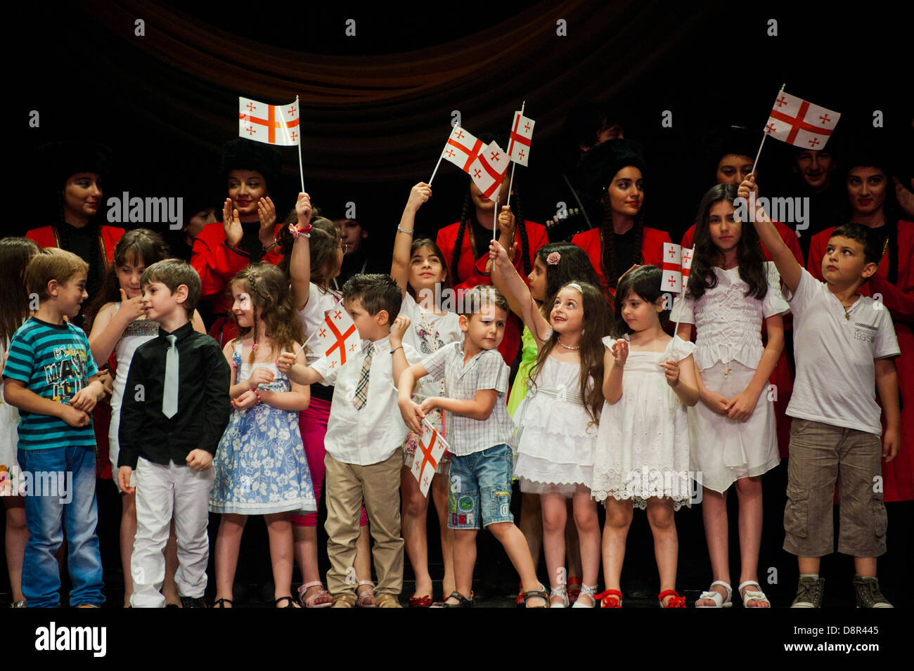 Georgian children dressed with traditional costumes dancing a folklore ...