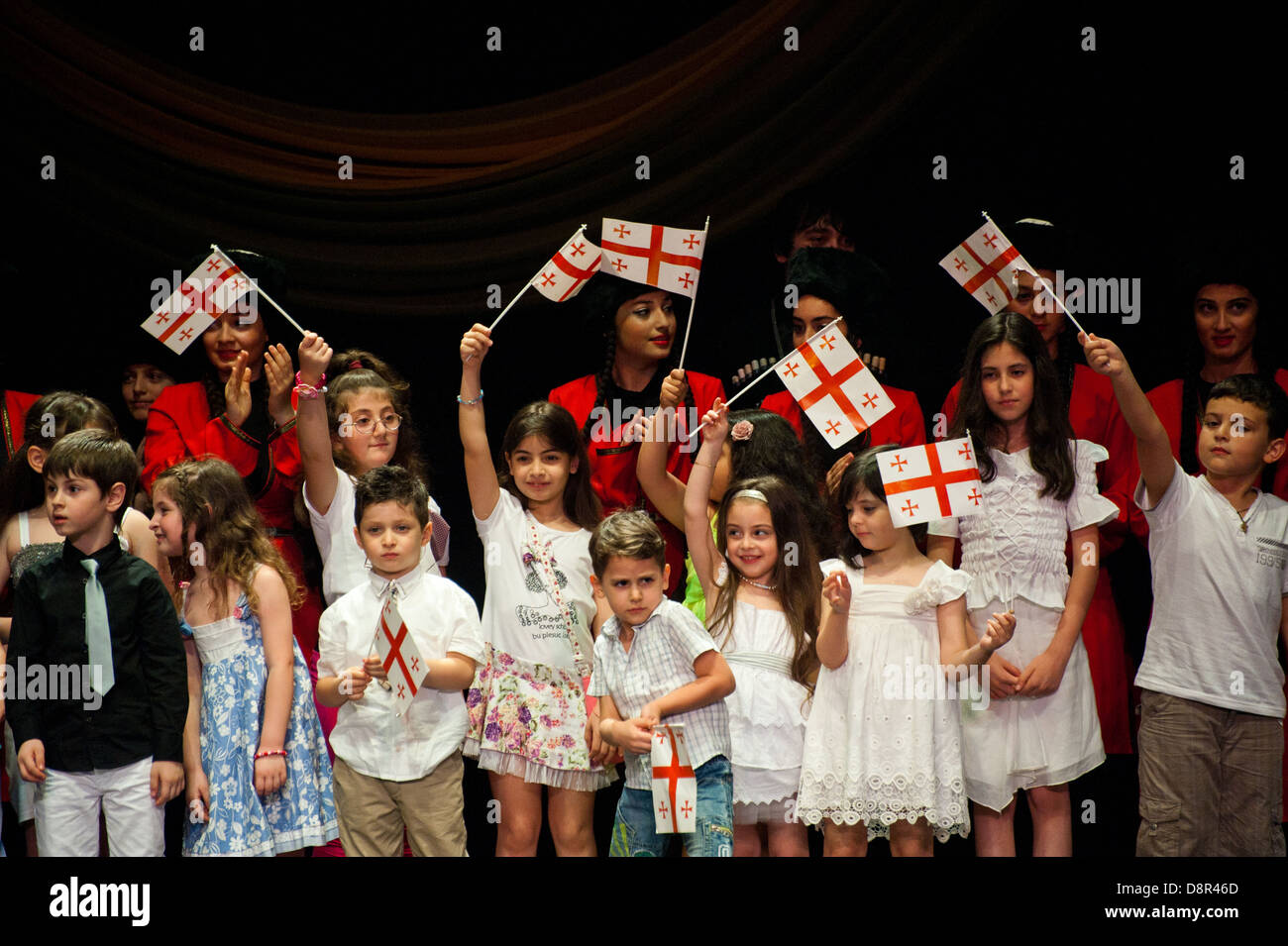 Georgian children dressed with traditional costumes dancing a folklore ...