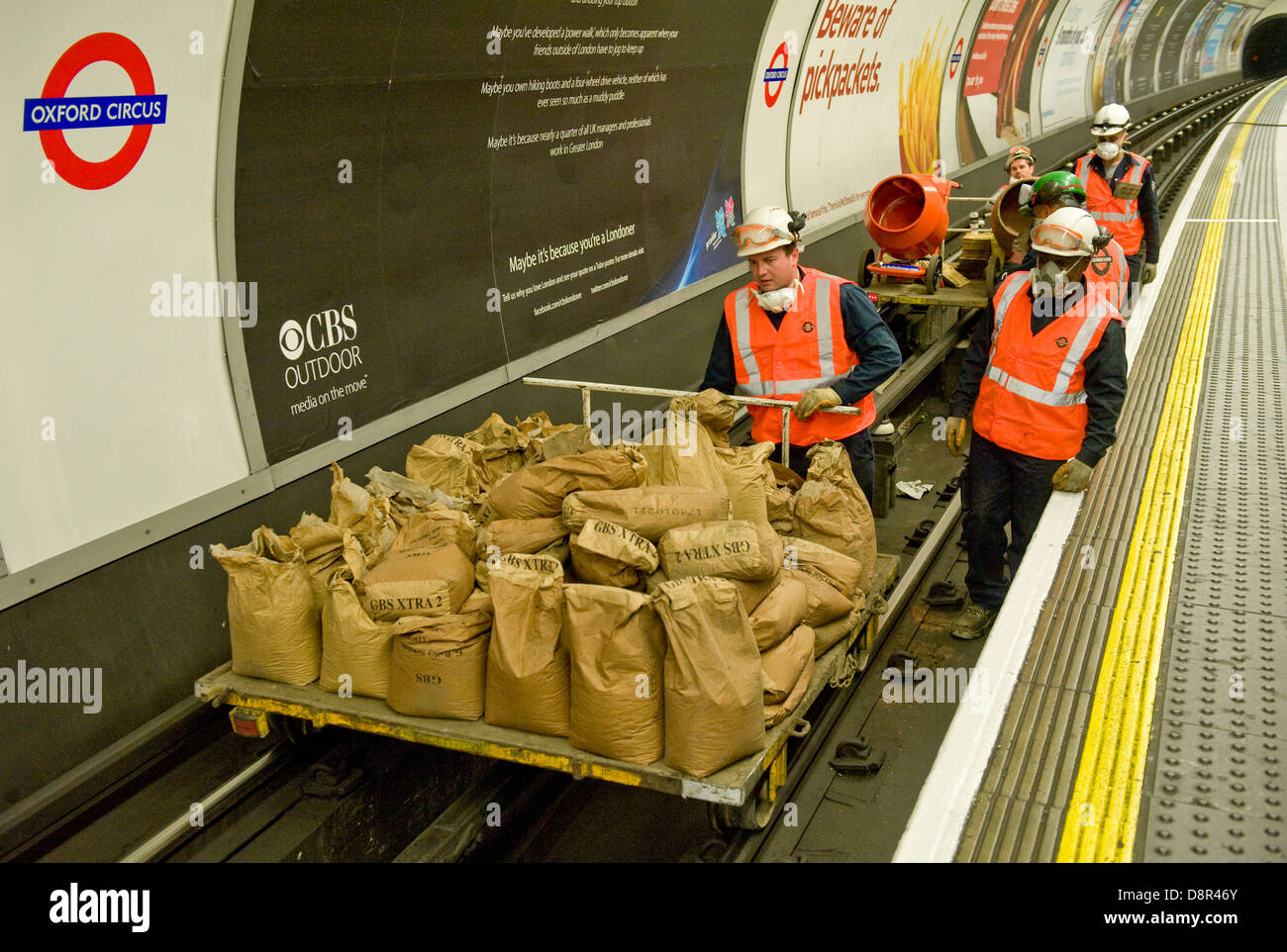 Workers set about digging, bagging up and hauling the old concrete ...