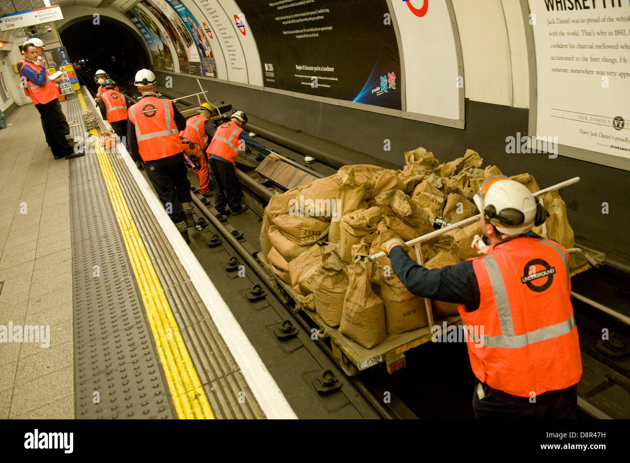 Workers set about digging, bagging up and hauling the old concrete ...