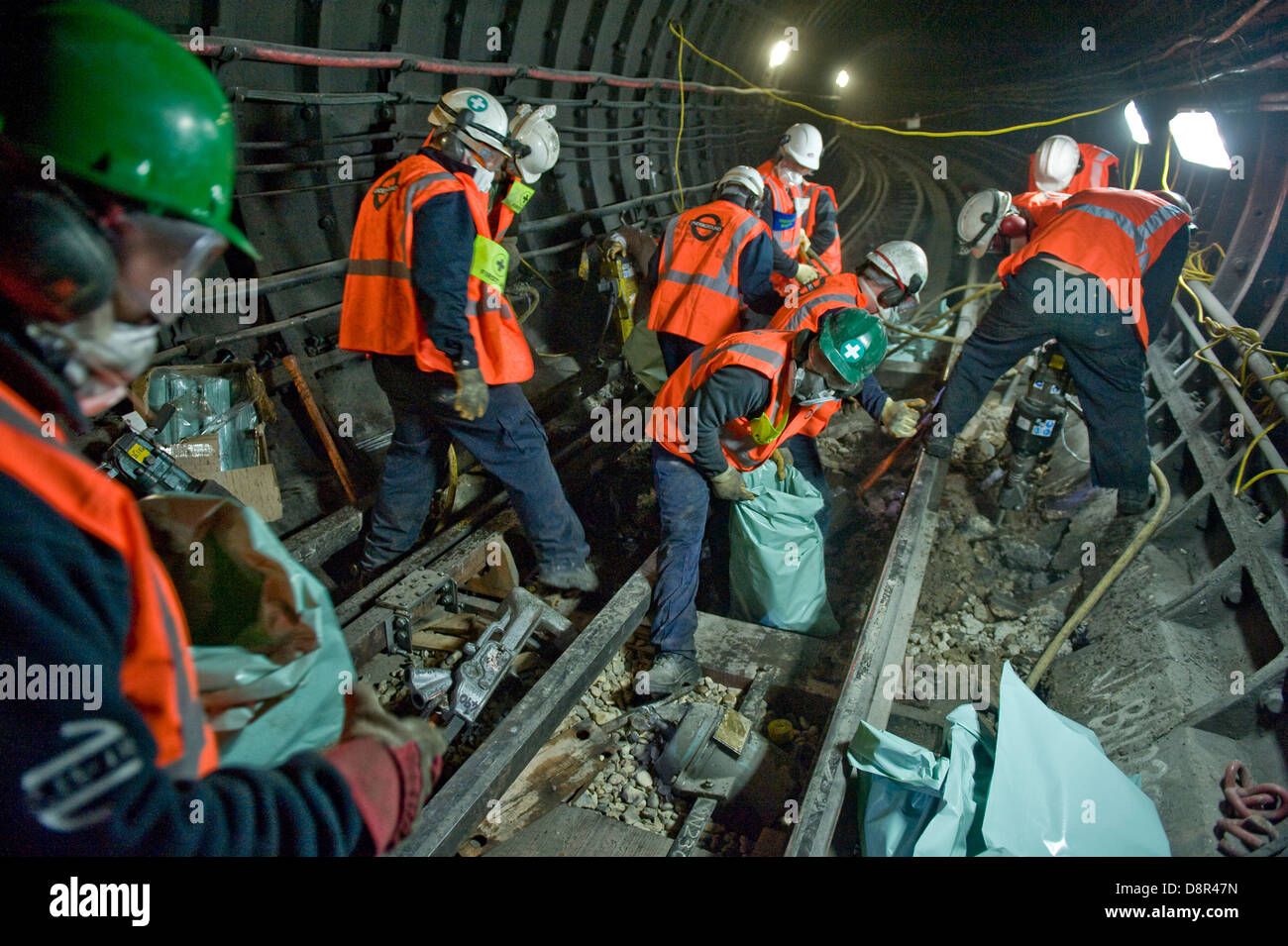 Workers set about digging, bagging up and hauling the old concrete ...
