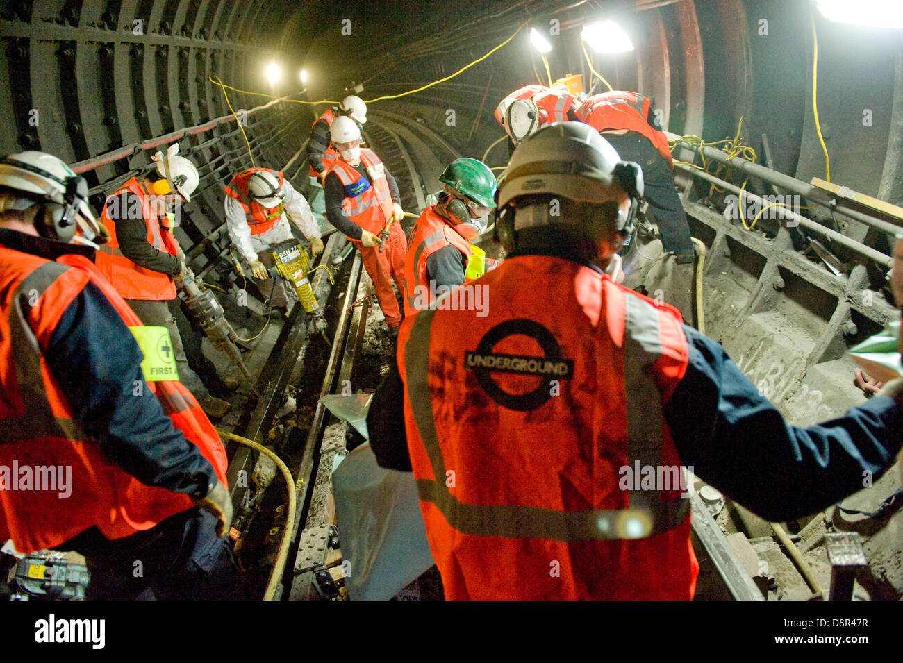 Workers set about digging, bagging up and hauling the old concrete ...