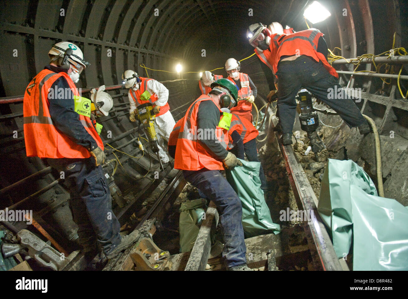 Workers set about digging, bagging up and hauling the old concrete ...