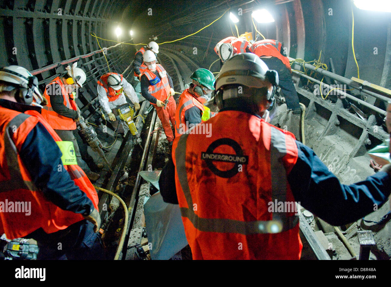Workers set about digging, bagging up and hauling the old concrete ...