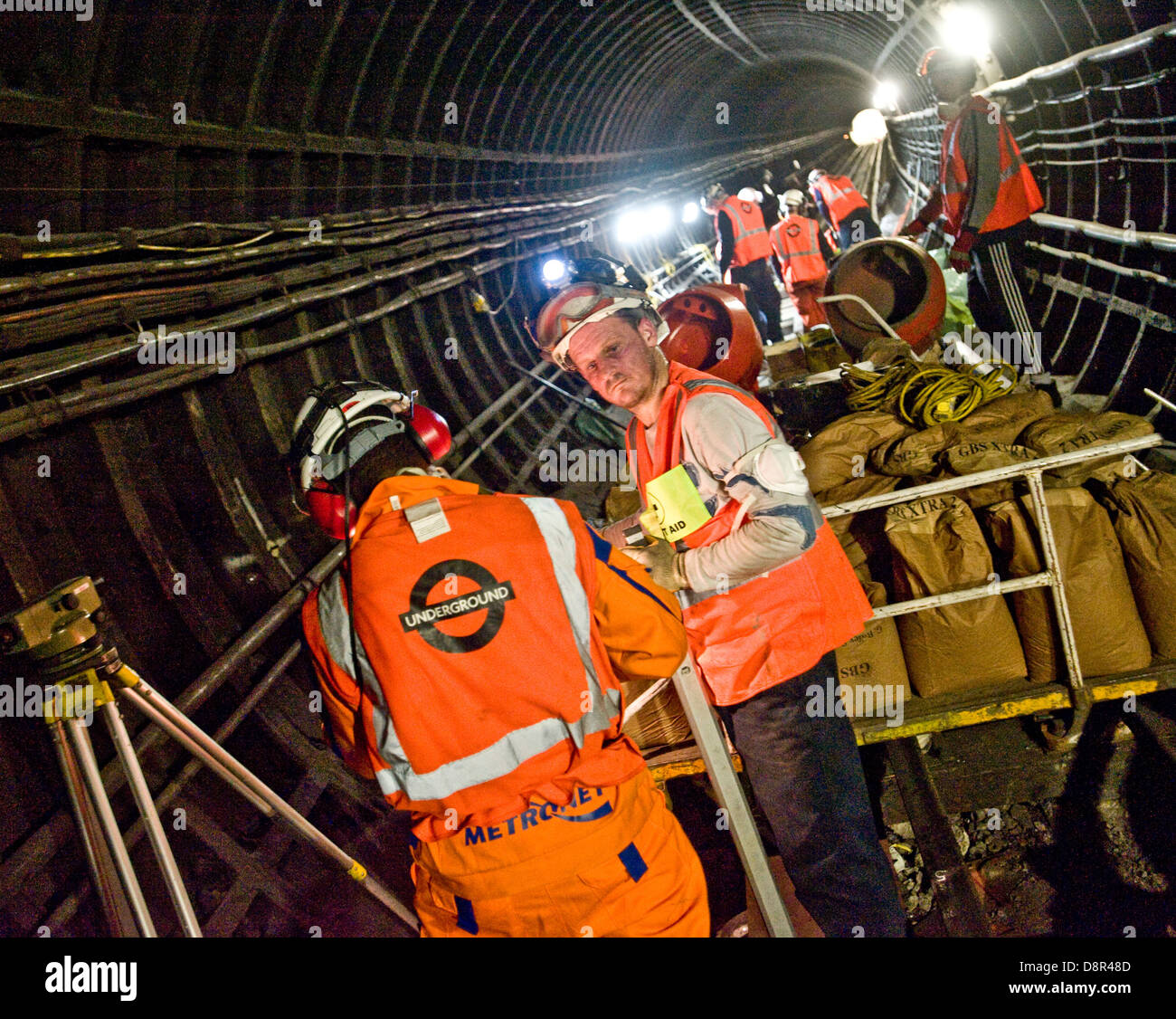 Workers set about digging, bagging up and hauling the old concrete ...