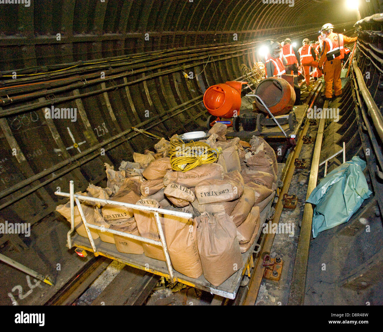 Workers set about digging, bagging up and hauling the old concrete ...