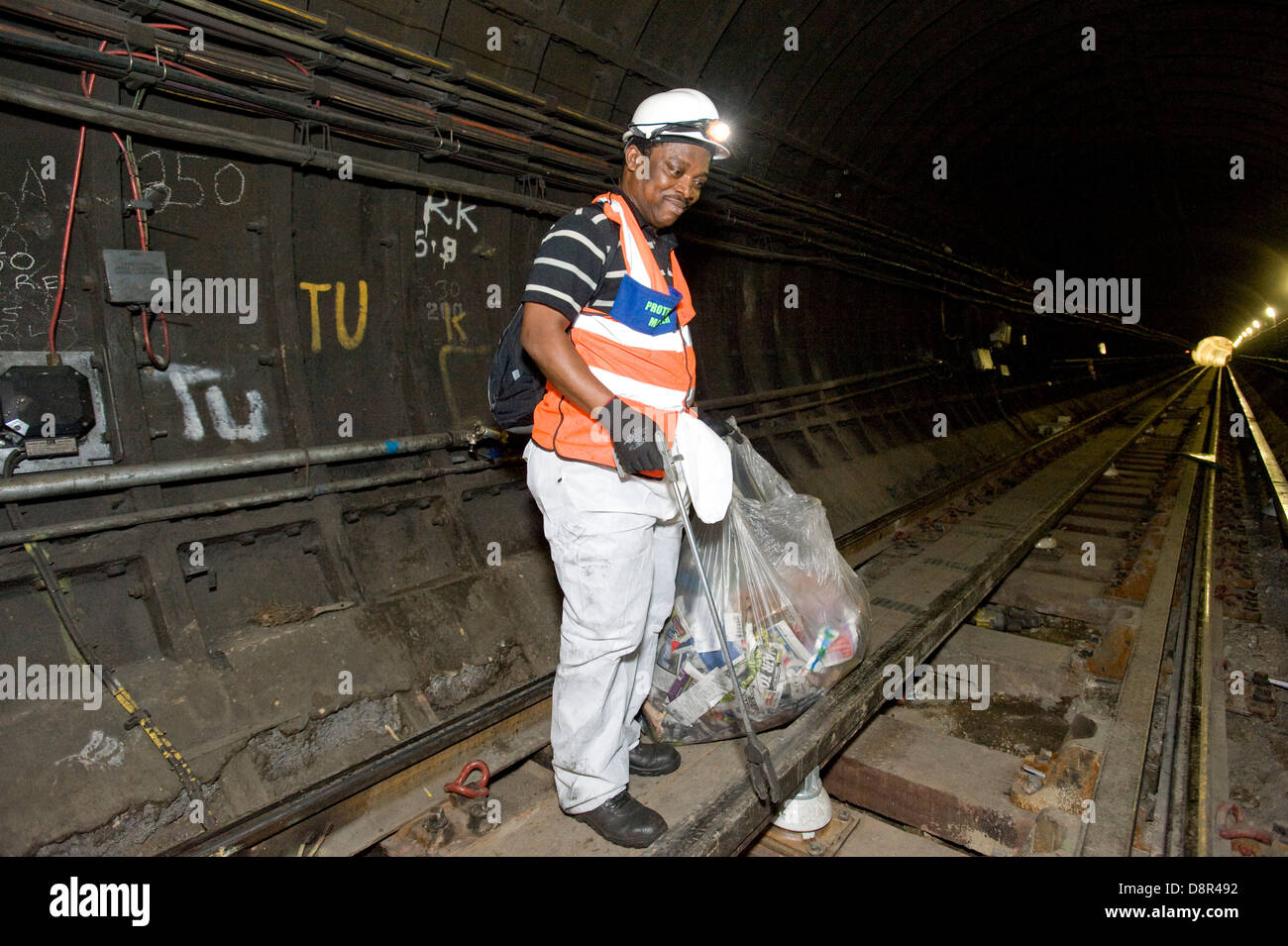 Workers set about digging, bagging up and hauling the old concrete ...