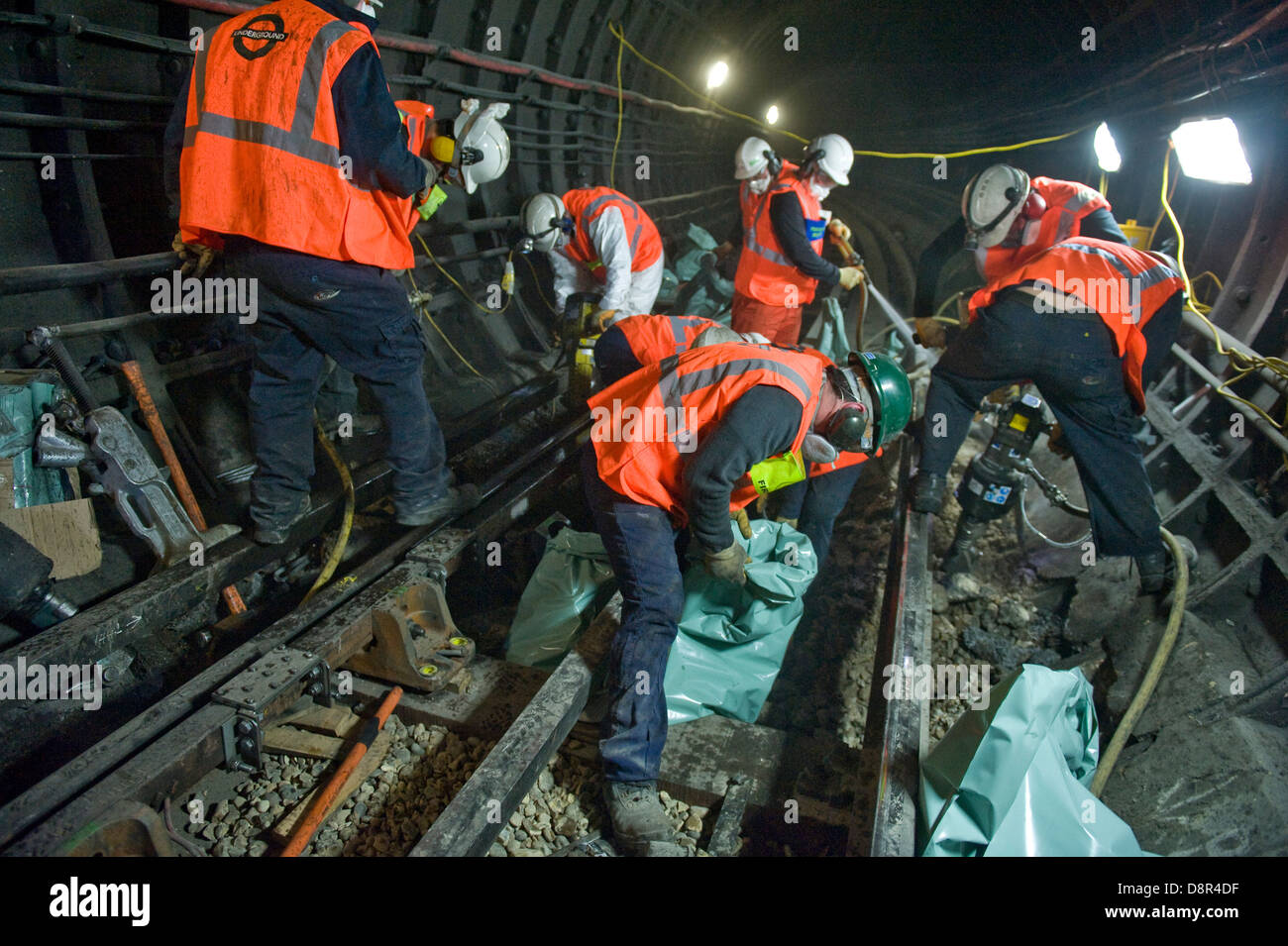 Workers set about digging, bagging up and hauling the old concrete ...